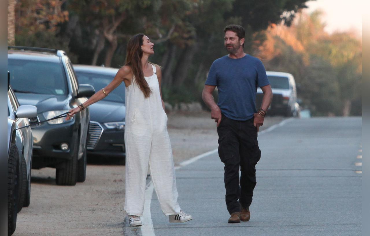 Gerard Butler and his girlfriend go for a walk on the beach in Malibu.