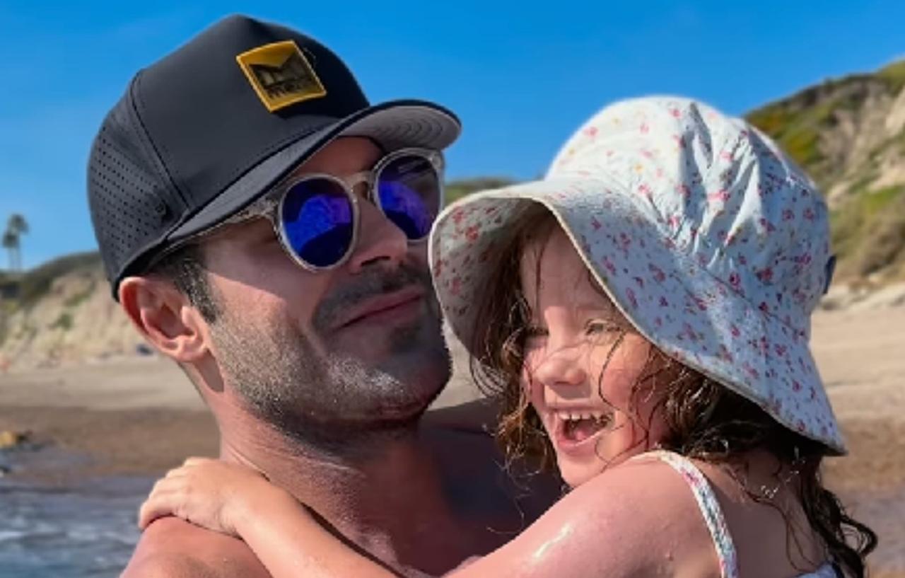 Zac Efron Sends Pulses Racing As He Cuddles With Little Sister: Photos