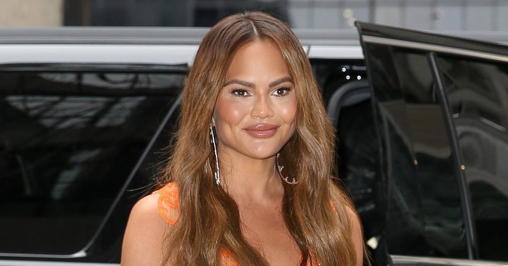 Chrissy Teigen Puts Long Legs On Display In Hot Pants, Sheer Tights