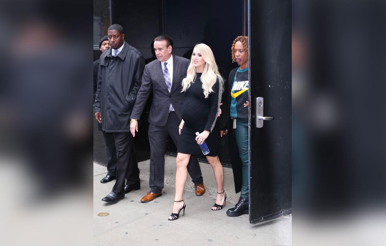 Carrie Underwood Shows Off Her Growing Belly Bump In A Black Dress