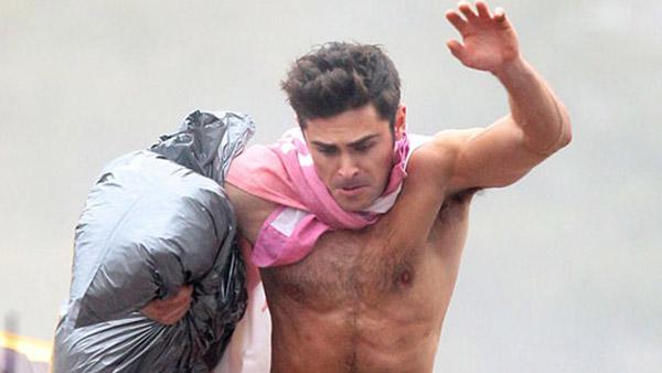 See Zac Efron Flaunt His Abs As He Leaps Over A Fire Pit!