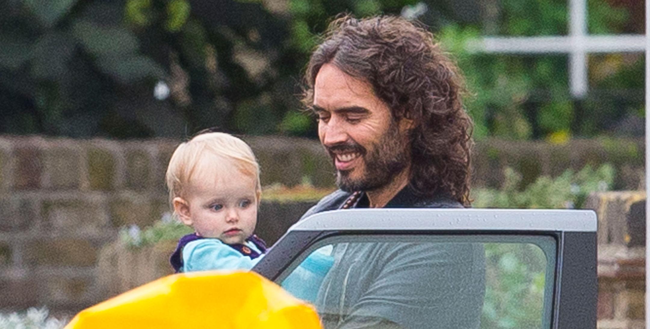 Russell Brand Cradles Precious Daughter During Stroll With Wife
