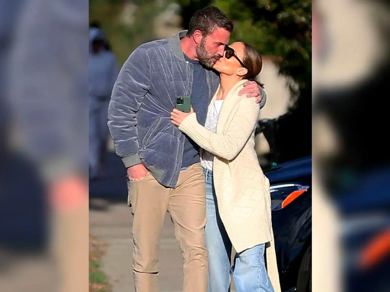 Ben Affleck Looks At His Phone While Kissing Wife Jennifer Lopez